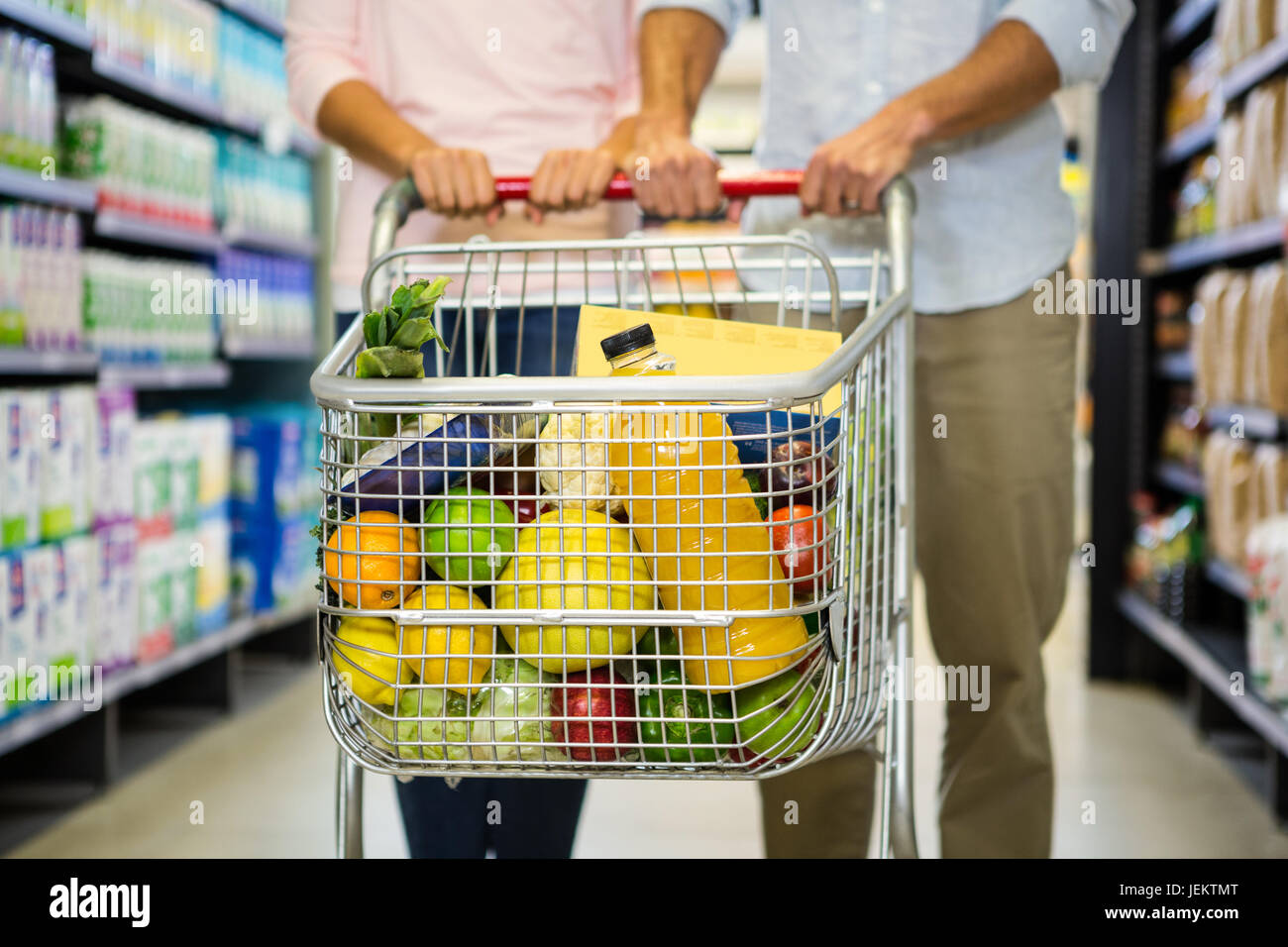 Couple pushing cart together Stock Photo - Alamy