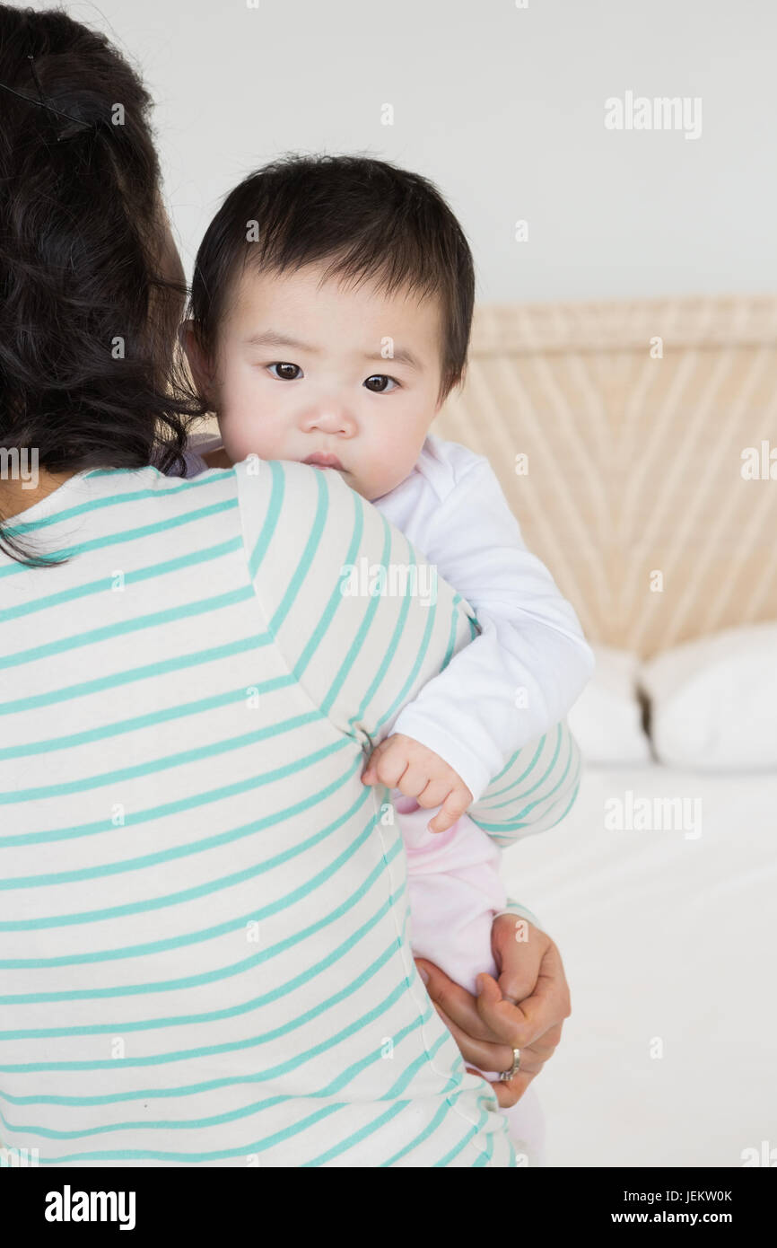 Lovely mother carrying baby daughter Stock Photo - Alamy