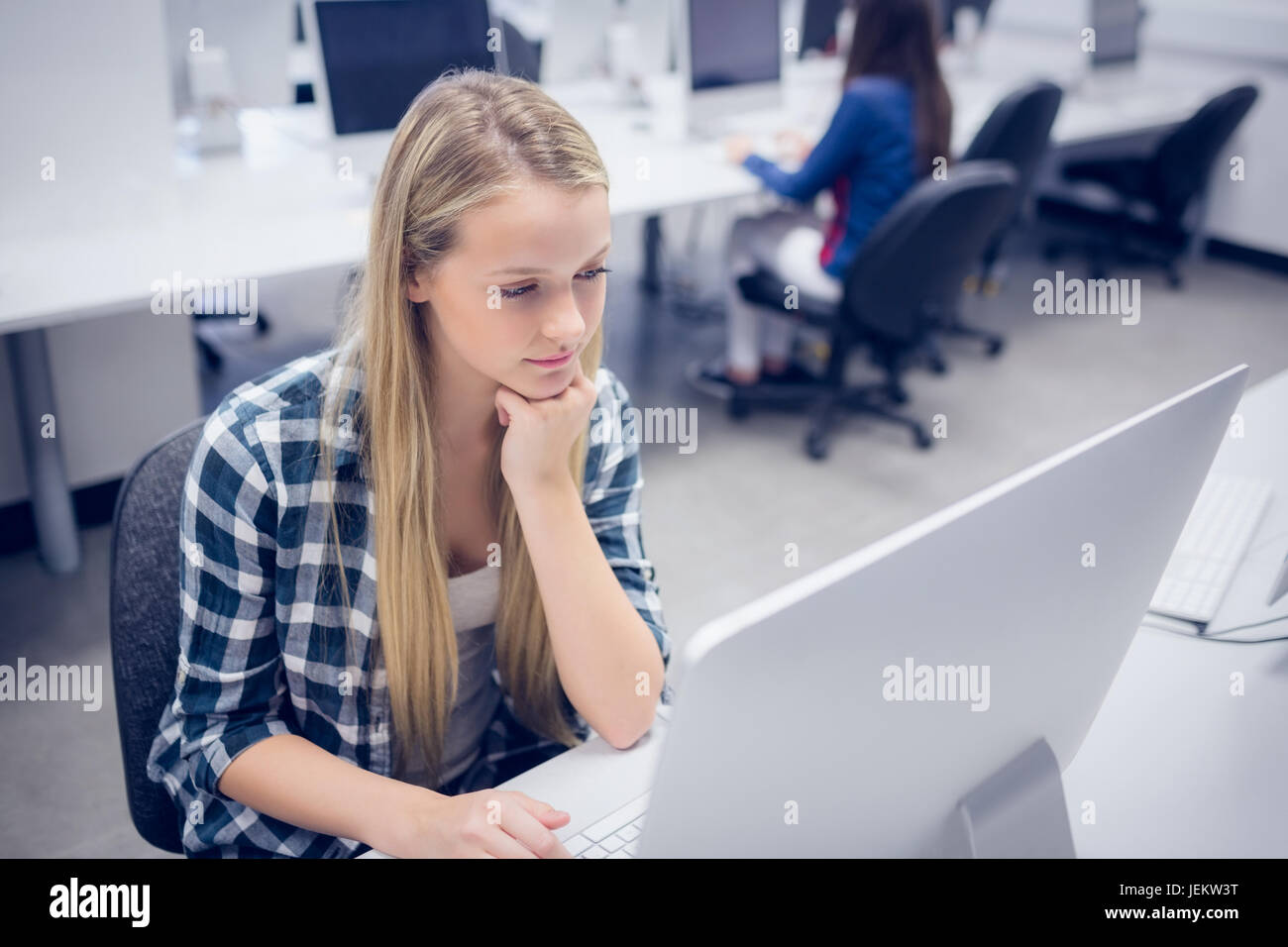 Serious student working on computer Stock Photo - Alamy