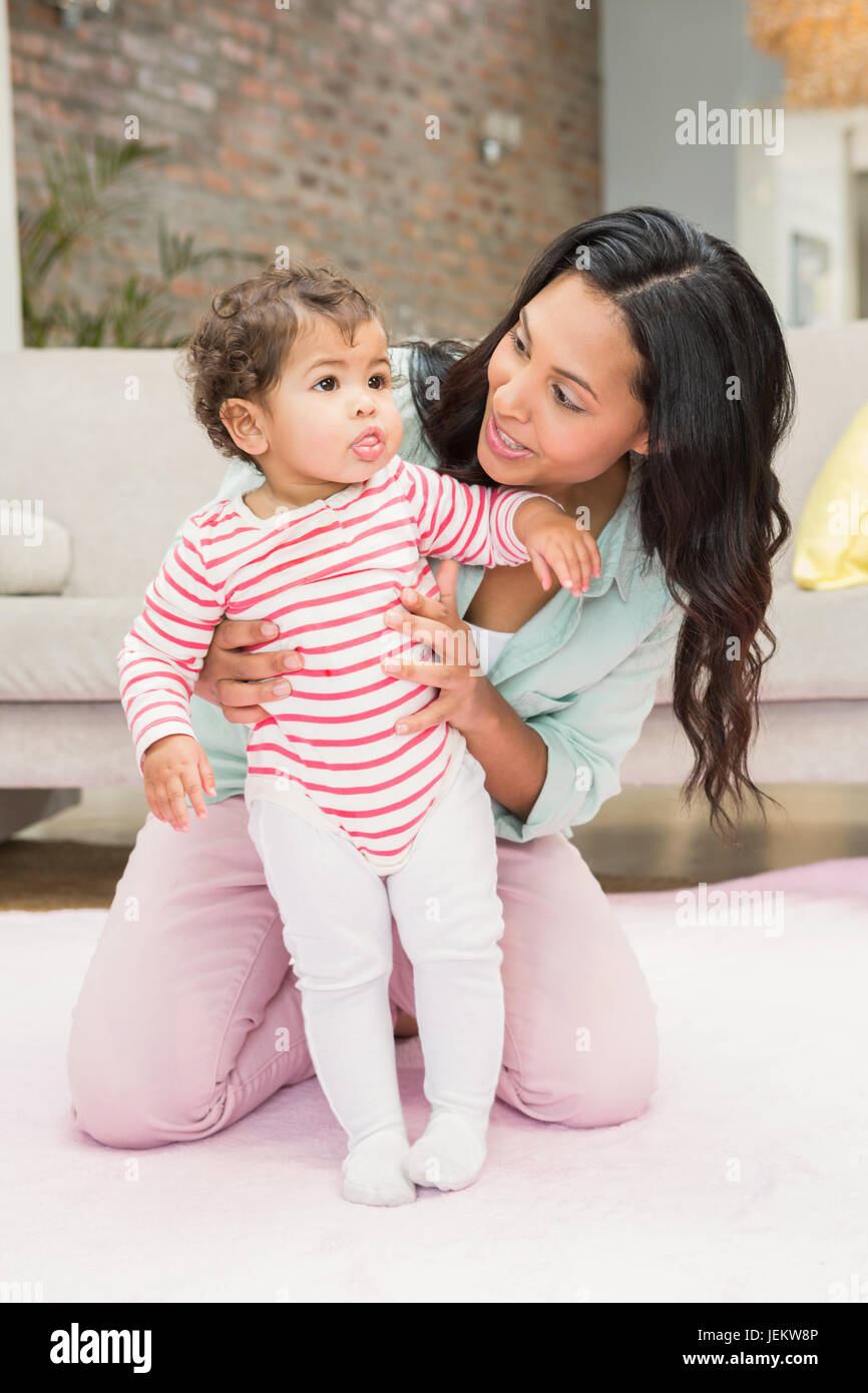 Mother with baby learning to walk Stock Photo - Alamy