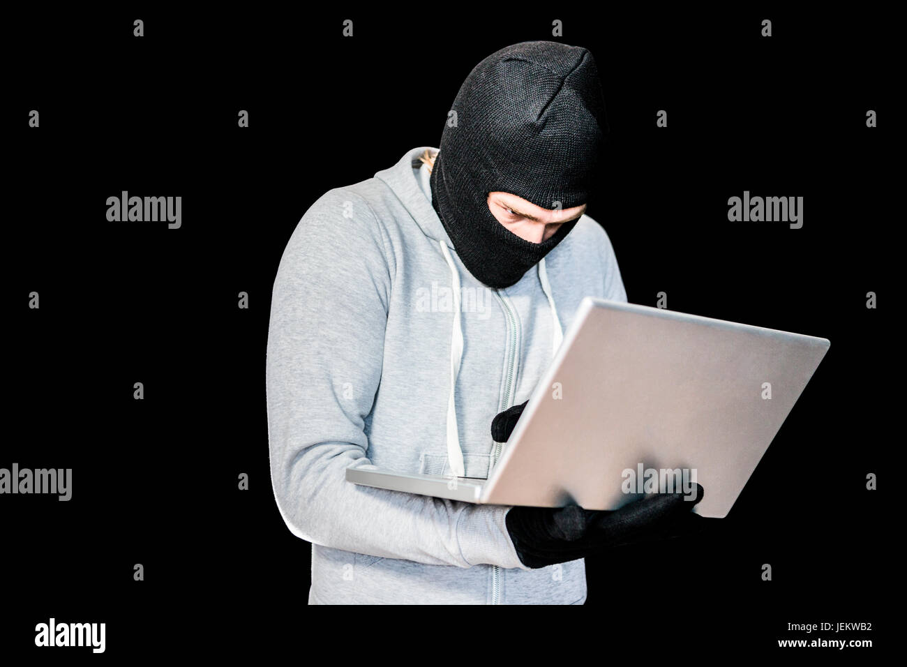 Focused thief hood typing hi-res stock photography and images - Alamy