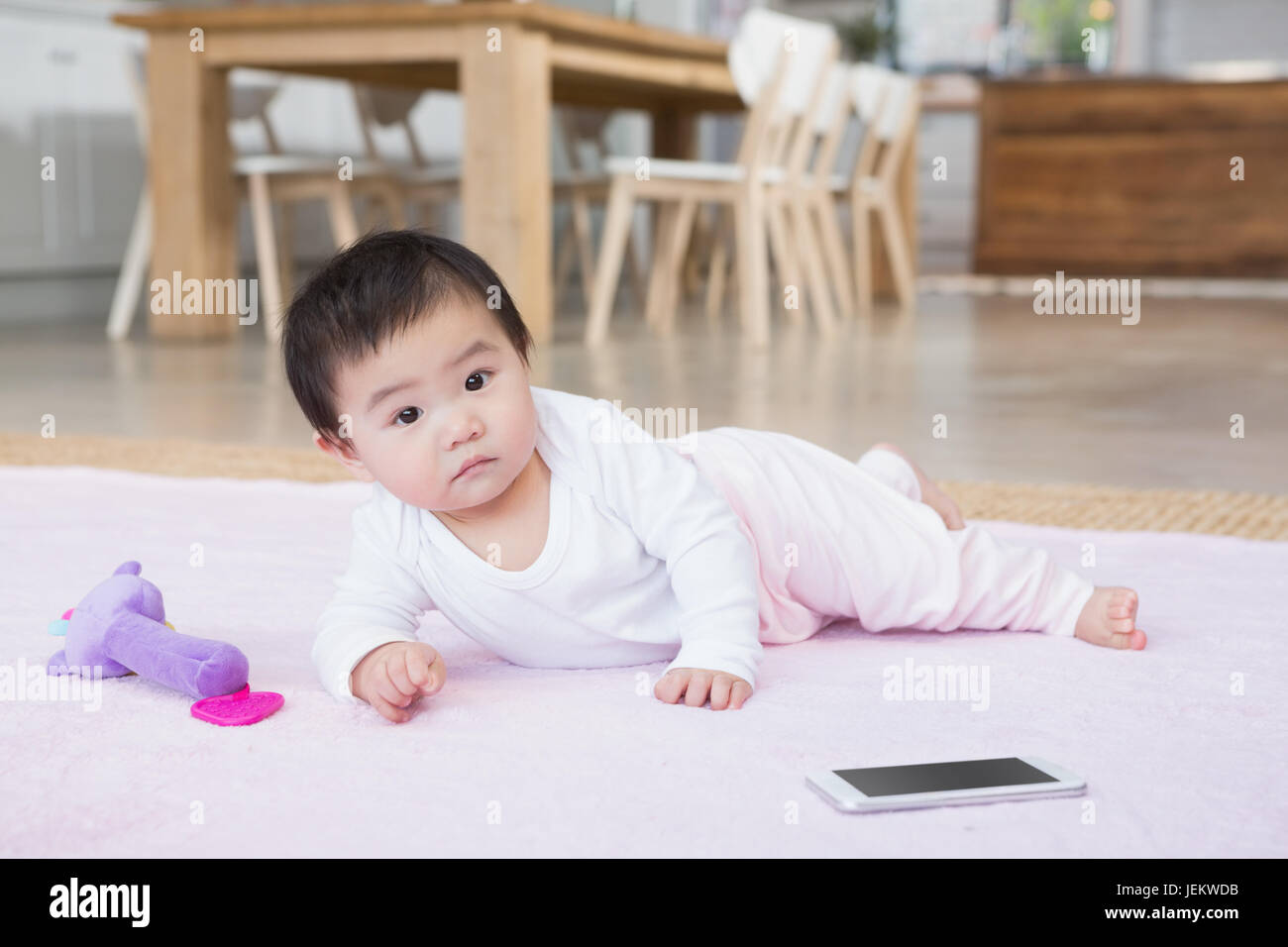 Cute baby on the carpet Stock Photo - Alamy