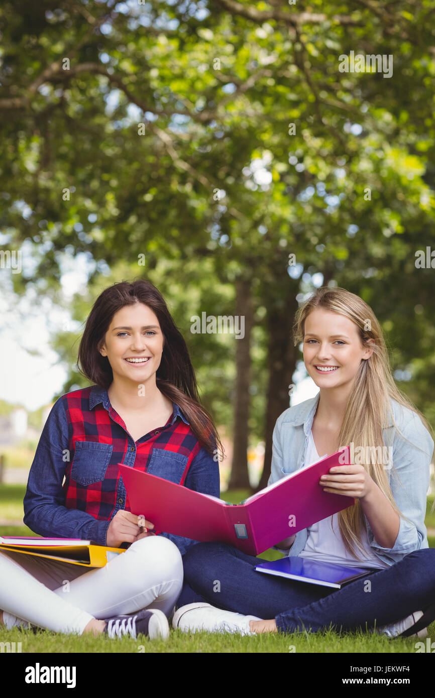 Smiling students holding binder Stock Photo - Alamy