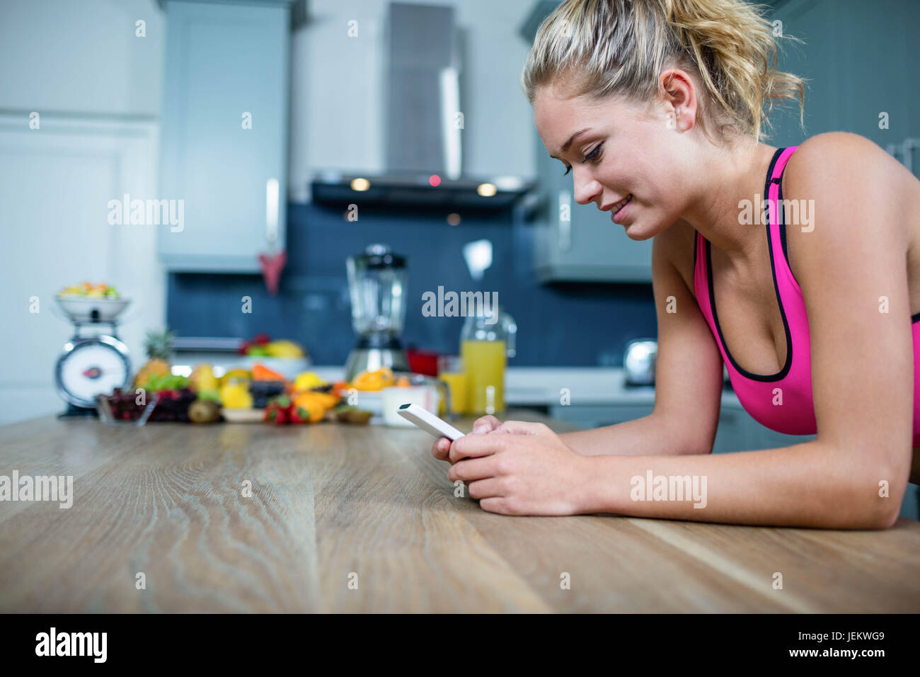 Fit girl sending text messages Stock Photo - Alamy