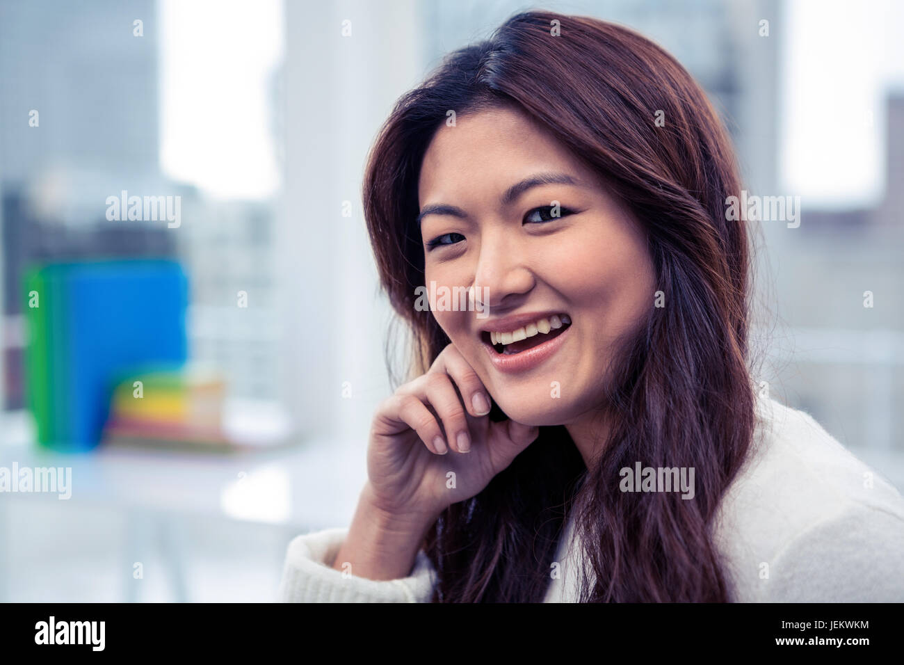 Smiling Asian woman with hand on cheek Stock Photo - Alamy