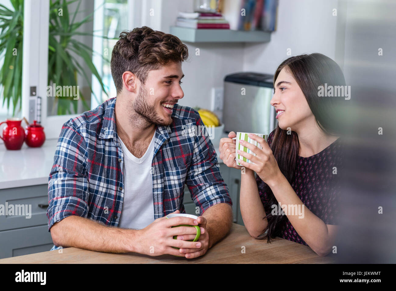 Happy couple having coffee together Stock Photo - Alamy