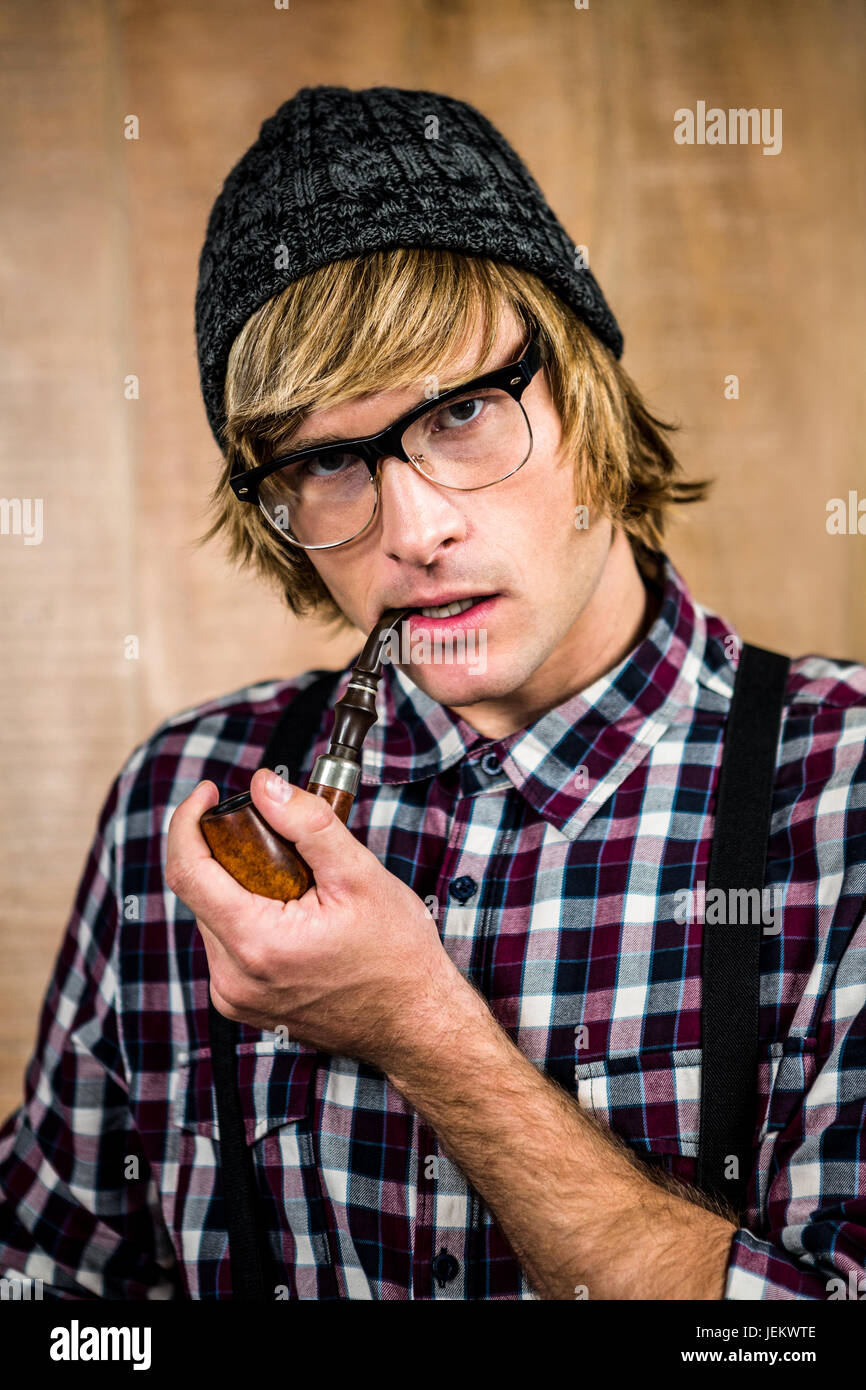 Serious blond hipster smoking a pipe Stock Photo - Alamy