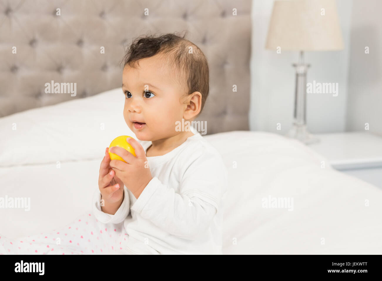 Cute baby playing with ball Stock Photo - Alamy