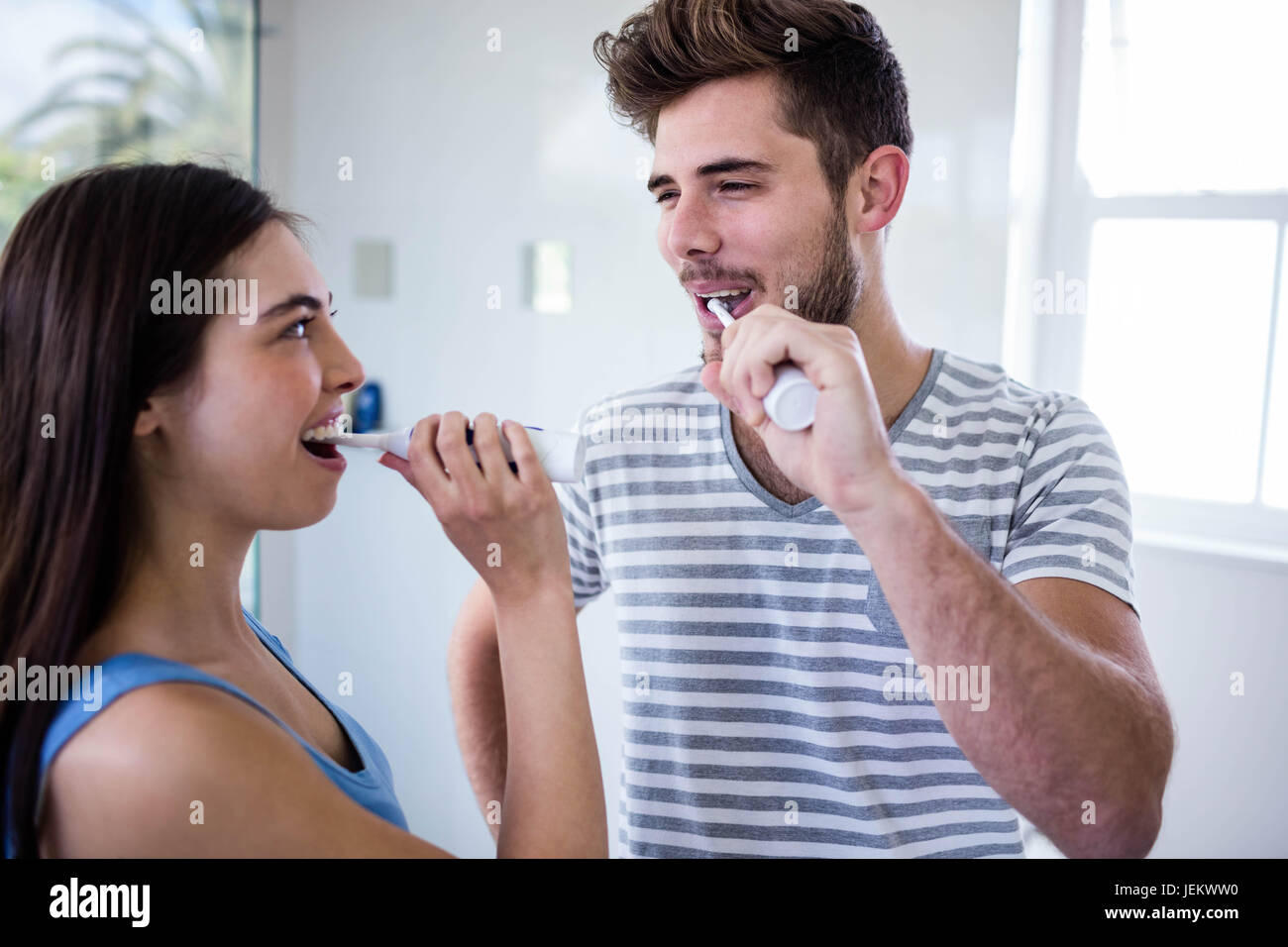 Couple brushing their teeth Stock Photo - Alamy