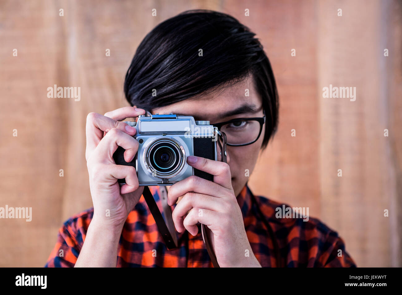 Hipster taking pictures with an old camera Stock Photo - Alamy