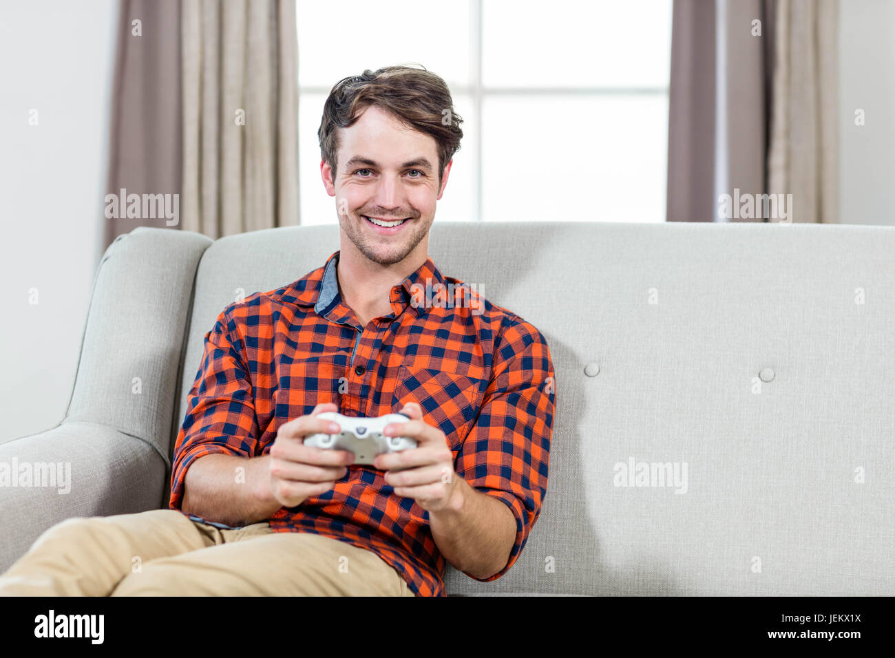 Happy man playing video games Stock Photo - Alamy