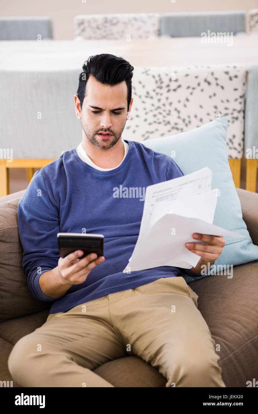 Handsome man counting bills Stock Photo - Alamy