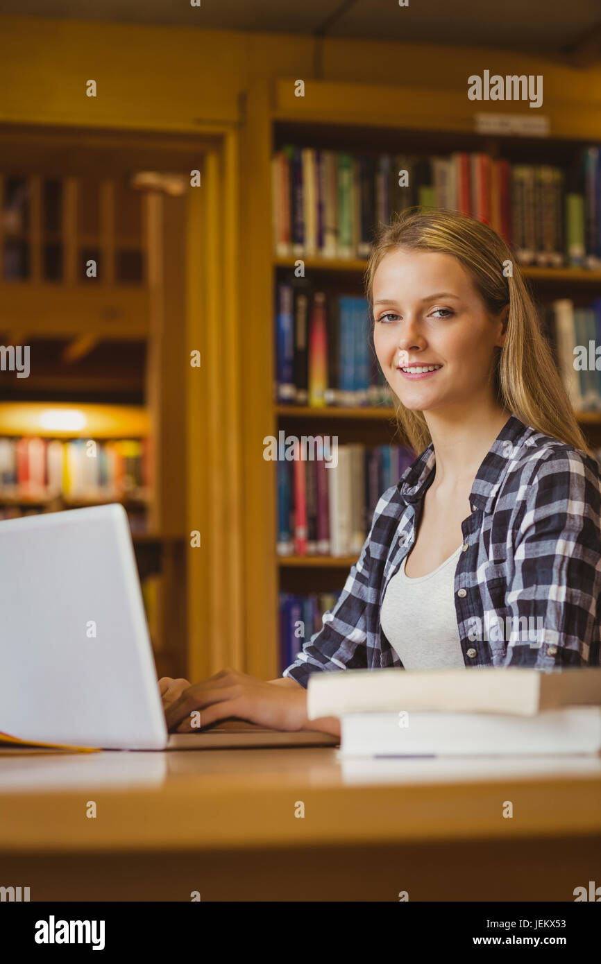 Smiling student working on laptop Stock Photo - Alamy
