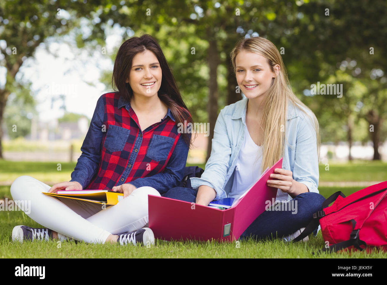 Smiling students holding binder Stock Photo - Alamy