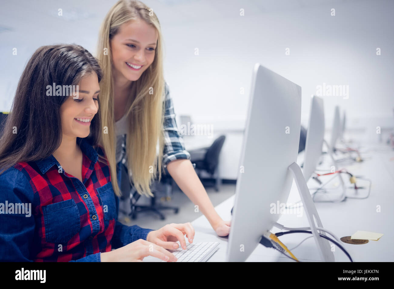 Smiling students using computer Stock Photo - Alamy