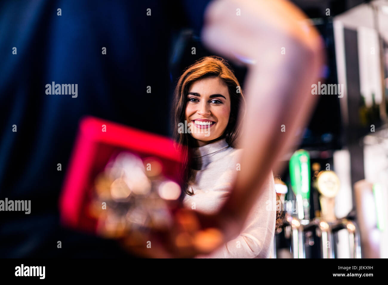 Man hiding gift box behind back Stock Photo - Alamy