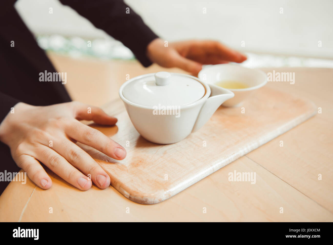 Hands holding Japanese Sencha Tea in clay pot Stock Photo - Alamy