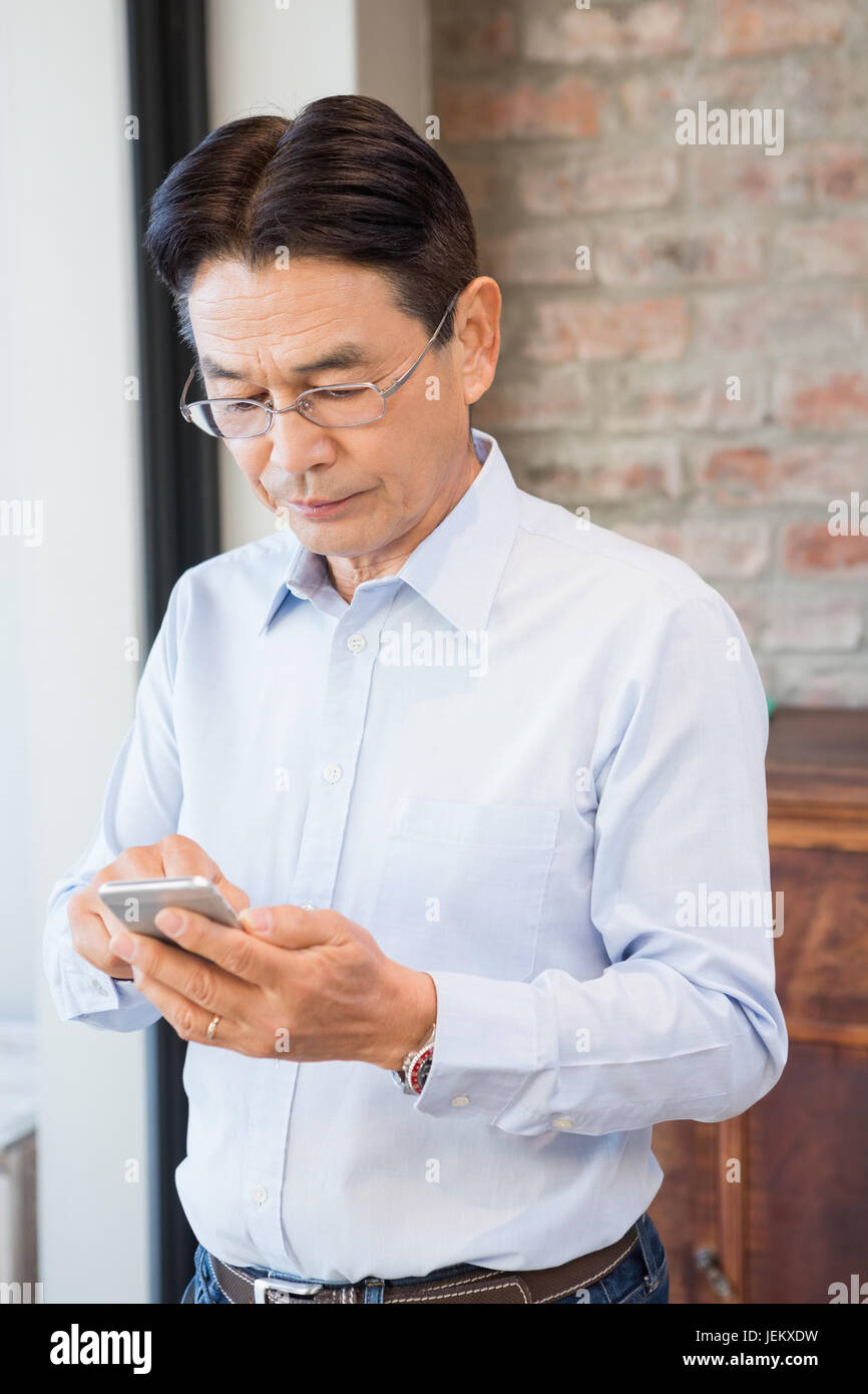 Serious man using smartphone Stock Photo - Alamy