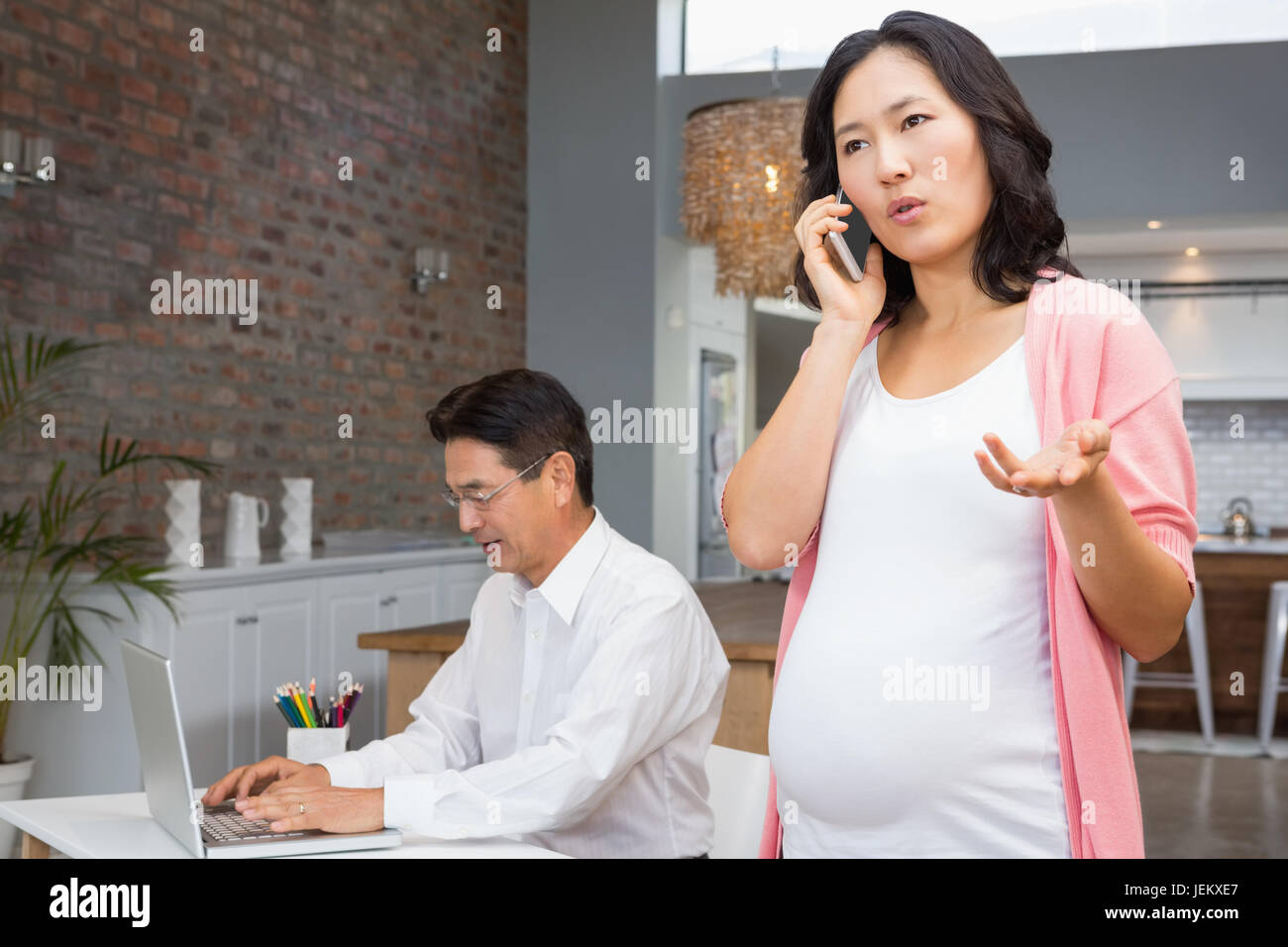 Smiling pregnant woman on a phone call Stock Photo - Alamy