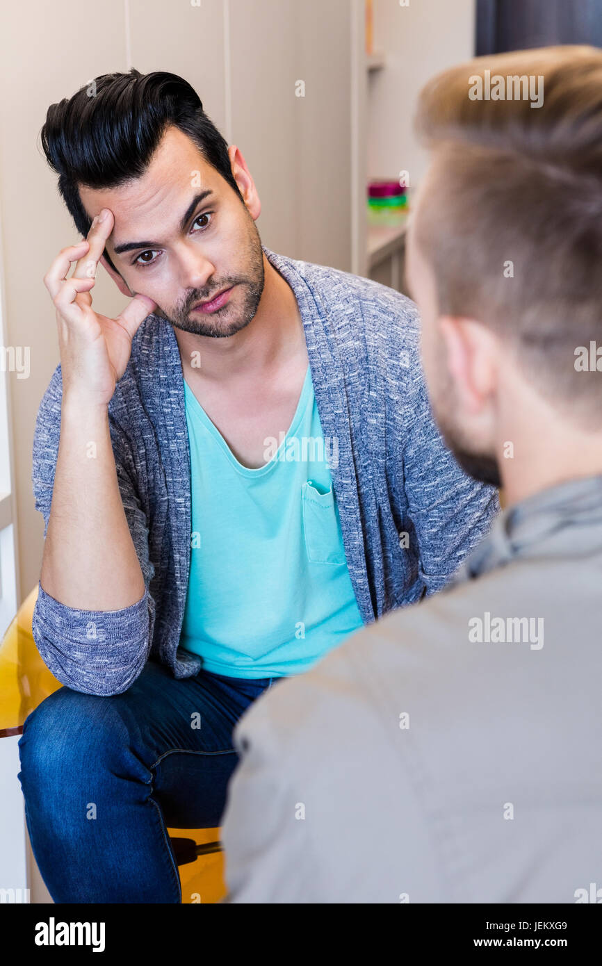 Thoughtful gay couple talking Stock Photo - Alamy