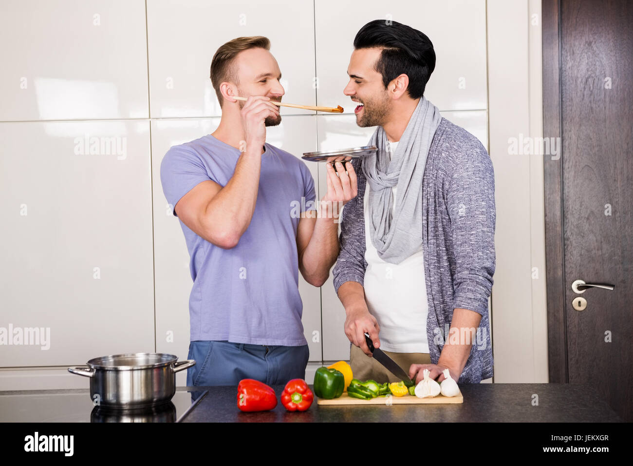 Smiling man tasting food Stock Photo - Alamy