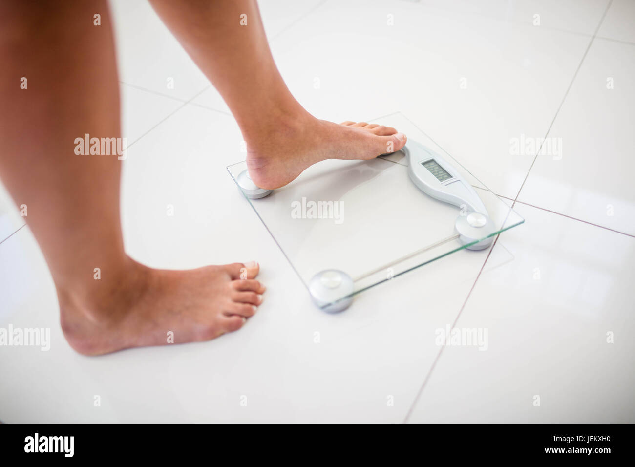 Womans feet going on weighting scale Stock Photo - Alamy