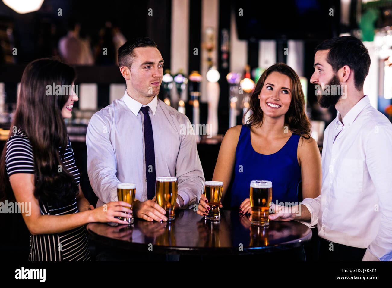 Friends talking and having a beer Stock Photo - Alamy