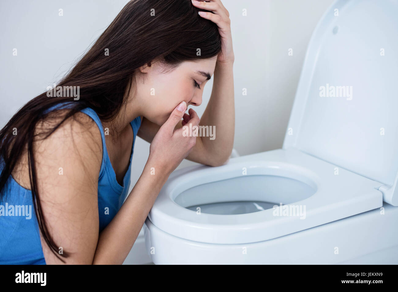 Rear view of woman throwing up Stock Photo - Alamy