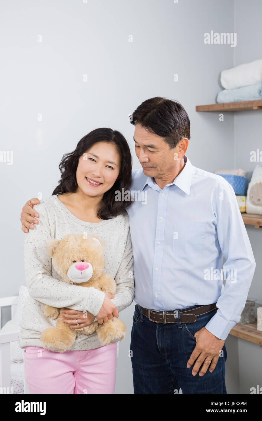 Smiling couple with teddy bear Stock Photo - Alamy