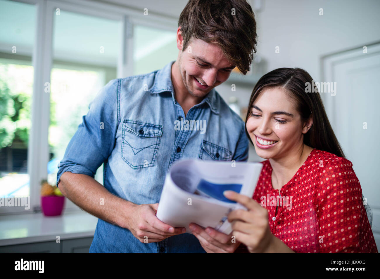 Happy couple reading newspaper Stock Photo - Alamy