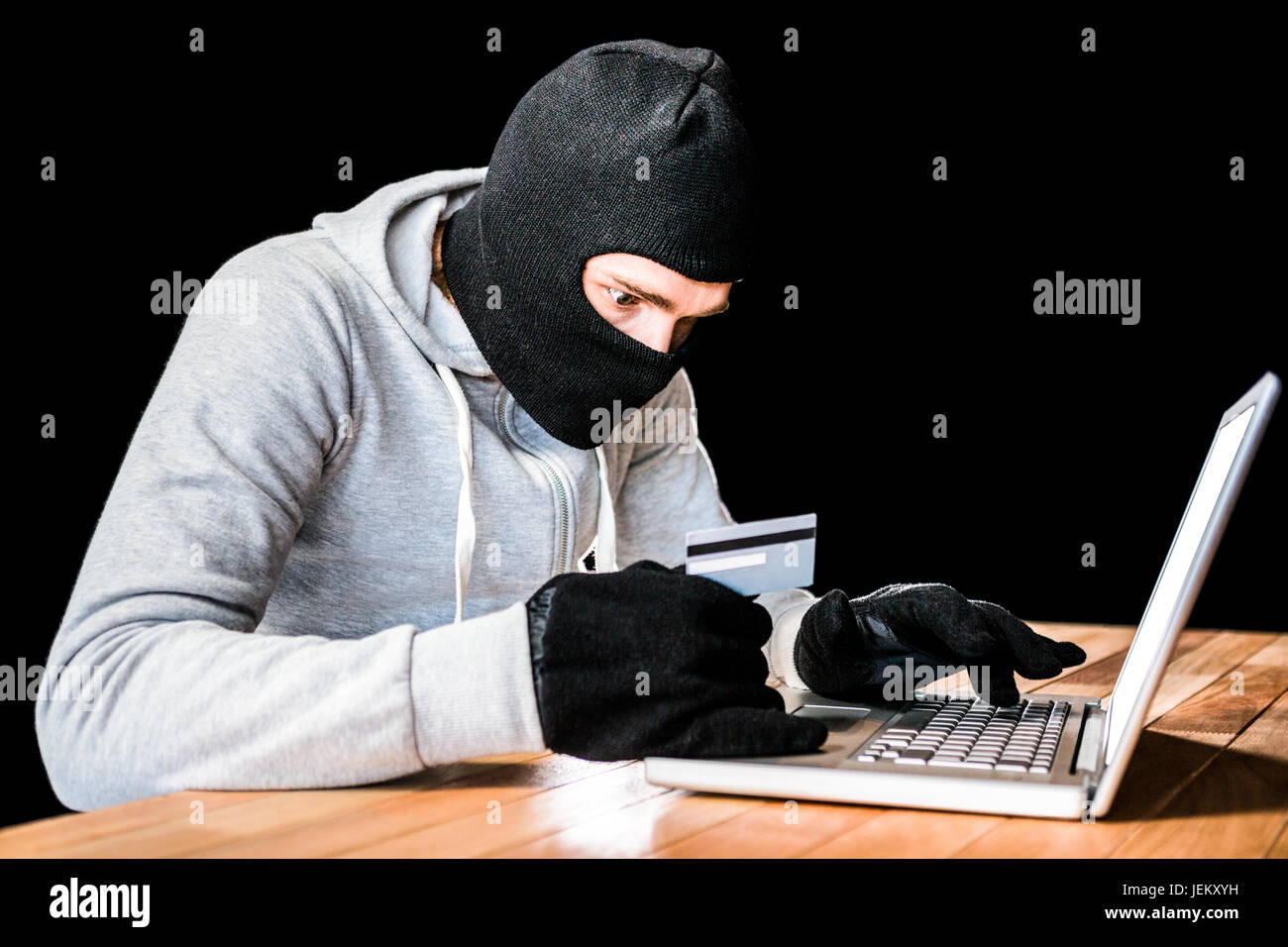 Focused thief hood typing hi-res stock photography and images - Alamy