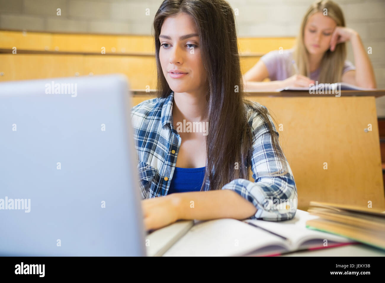 Smiling students working in class Stock Photo - Alamy