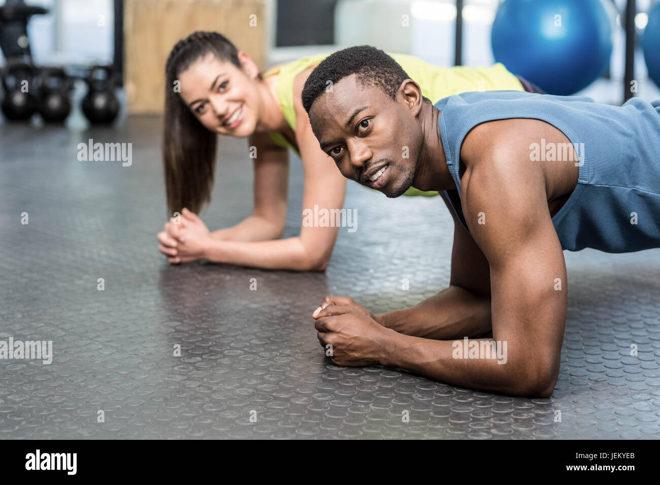 Athletic man and woman working out Stock Photo - Alamy