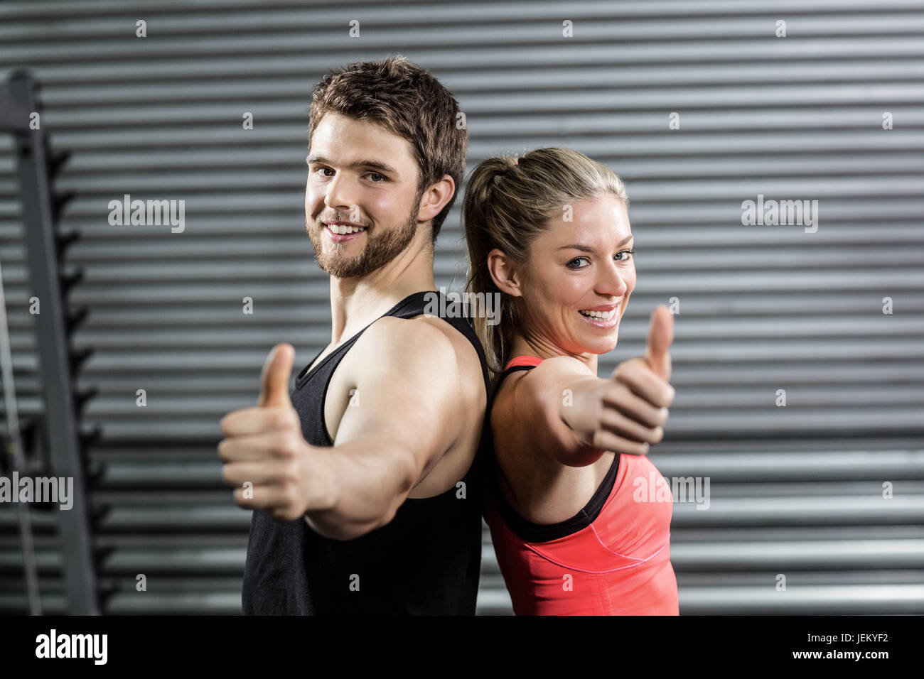 Serious couple standing back to back Stock Photo - Alamy