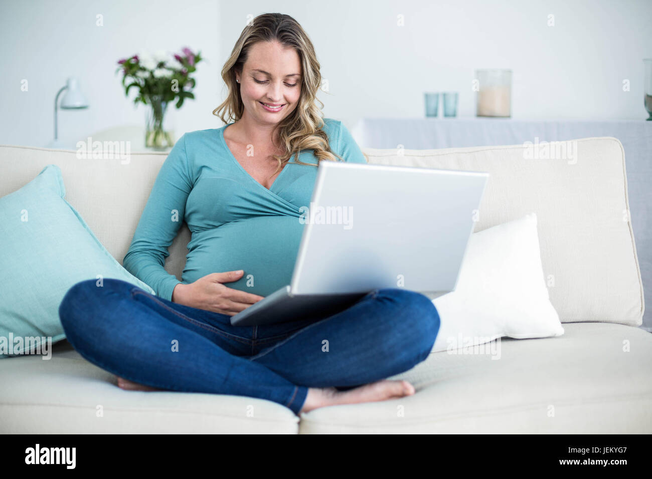 Pregnant woman using a laptop Stock Photo - Alamy