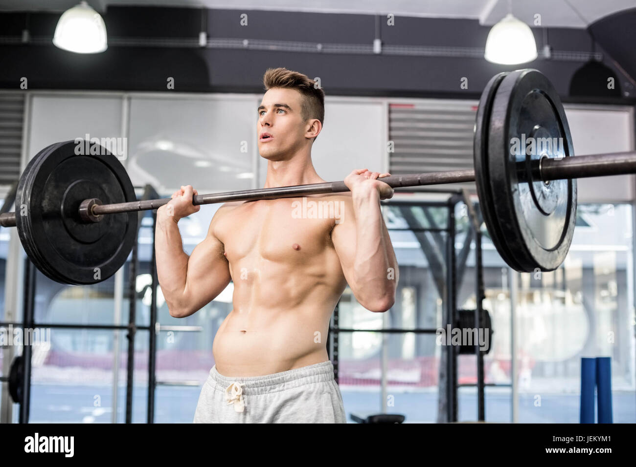 Fit man lifting barbell Stock Photo - Alamy