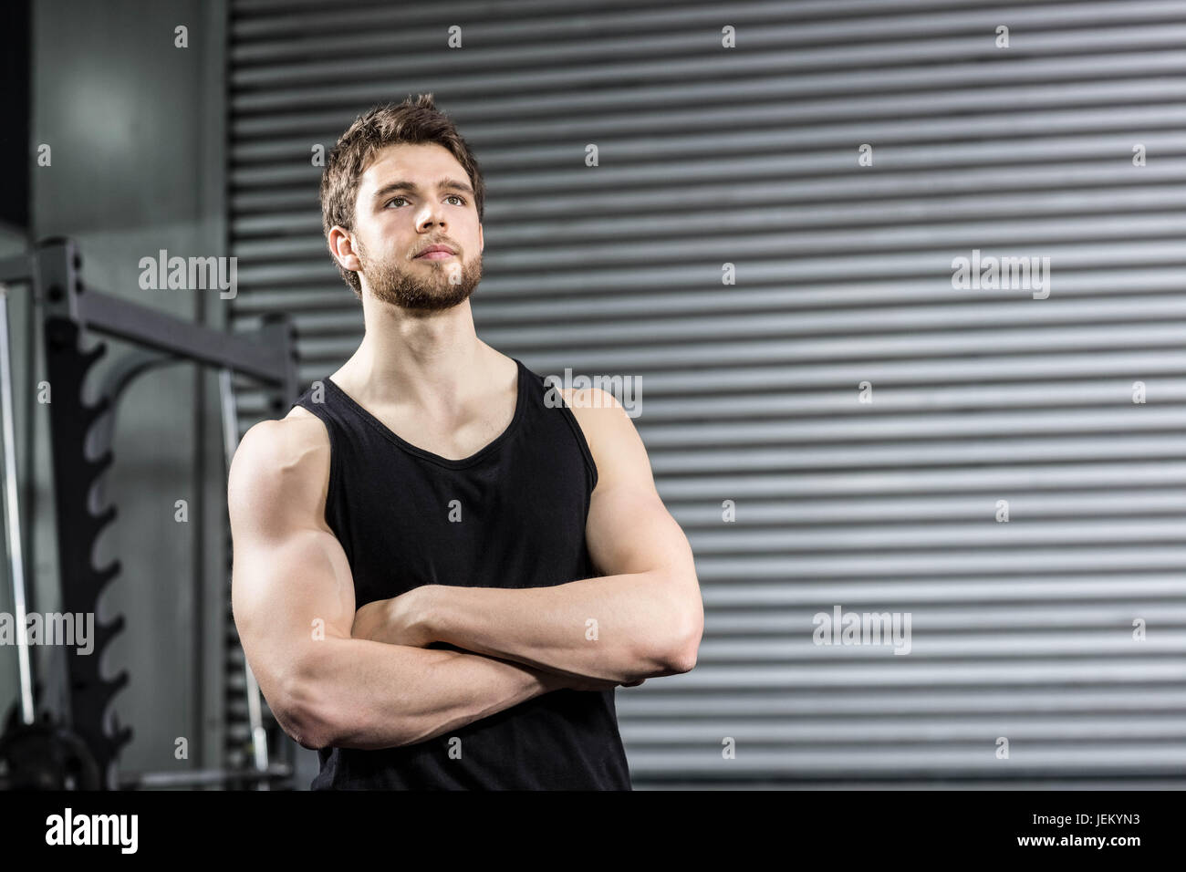 Serious muscular man arms folded hi-res stock photography and images ...