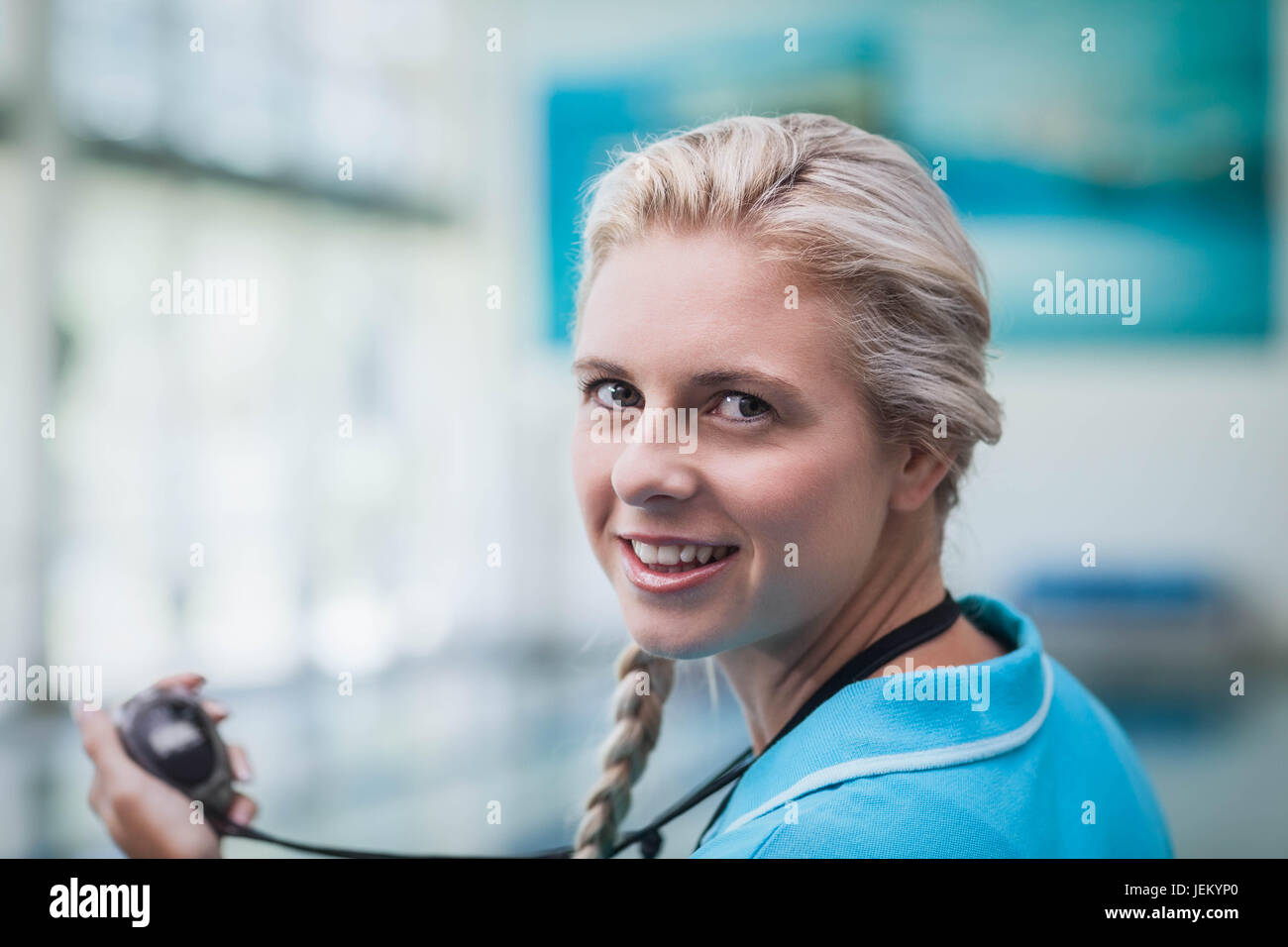 Pretty trainer holding a stopwatch Stock Photo - Alamy