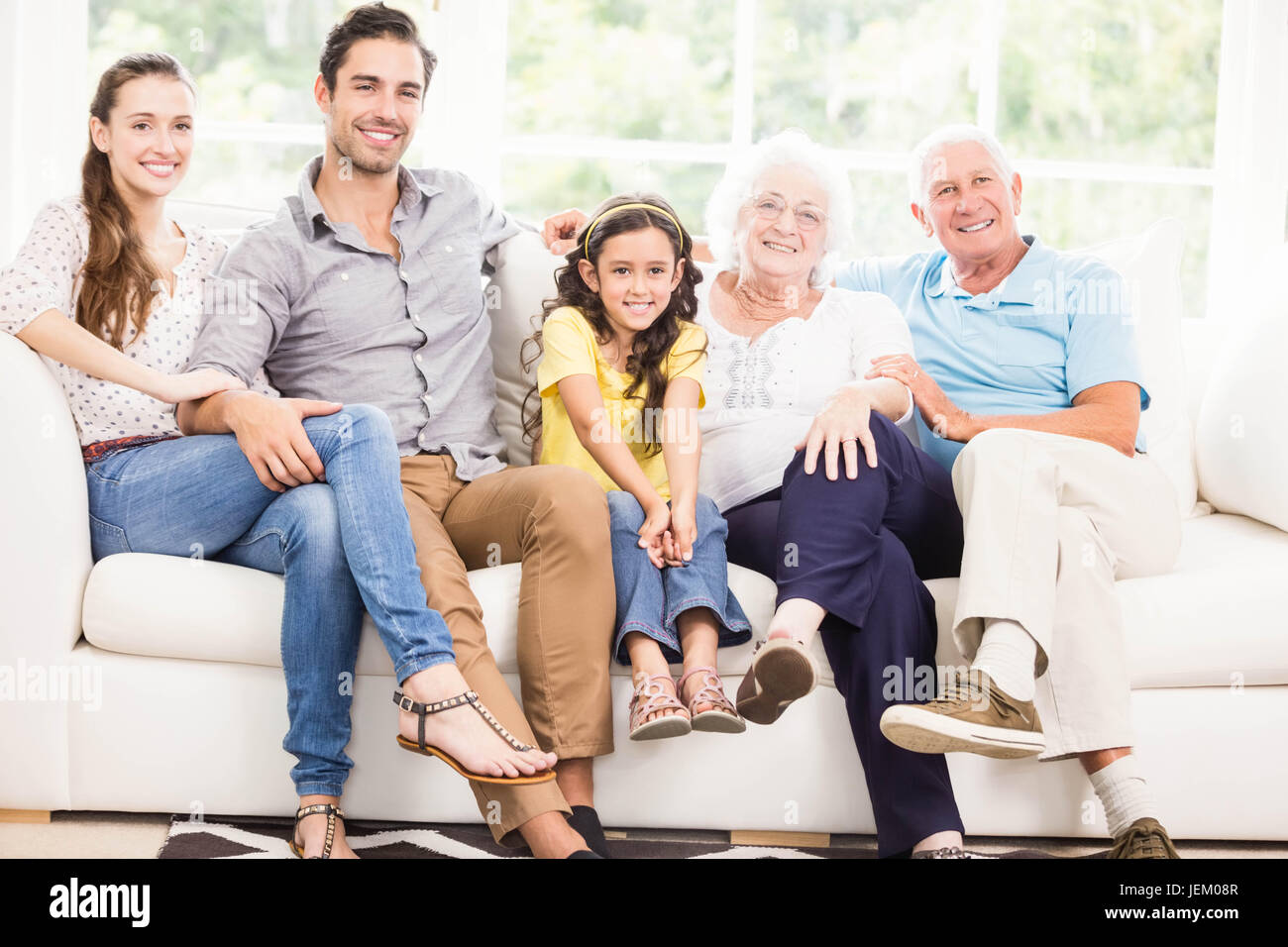 Happy extended family smiling Stock Photo - Alamy