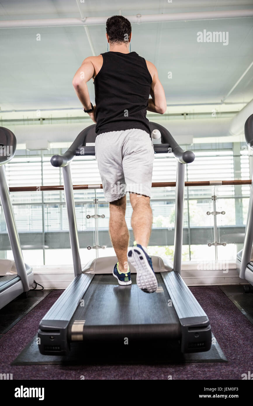 Fit man running on treadmill Stock Photo - Alamy
