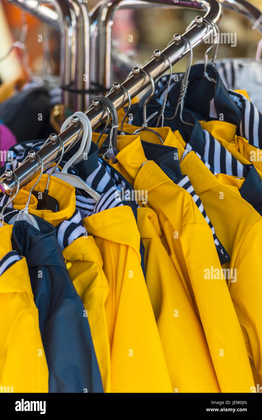 Bright autumn raincoats hanging at a fashion store Stock Photo - Alamy