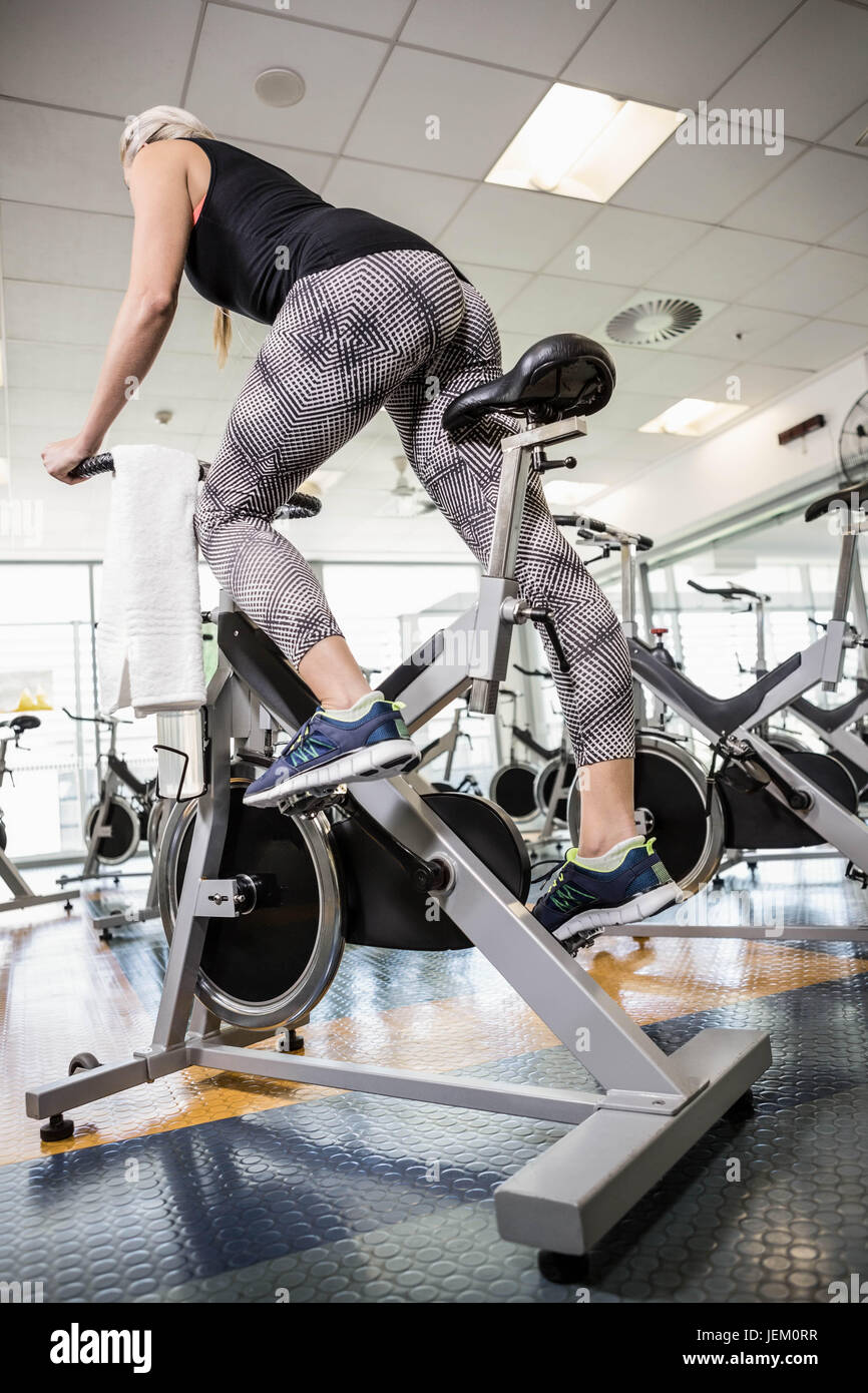 Fit woman on exercise bike Stock Photo - Alamy