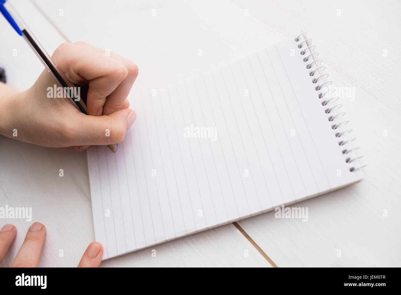 Woman sitting wall writing notebook hi-res stock photography and images ...