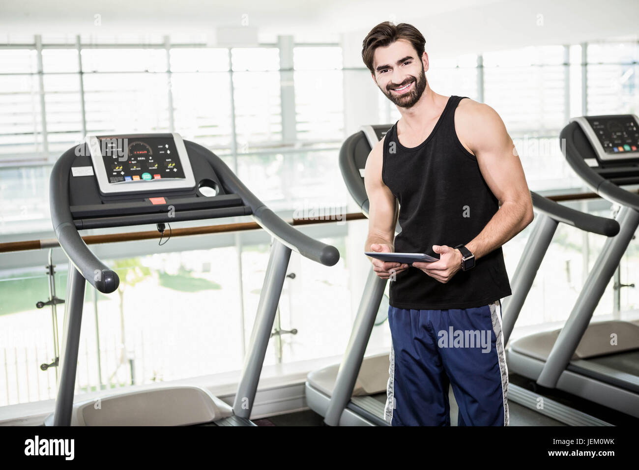 Smiling man using tablet Stock Photo - Alamy