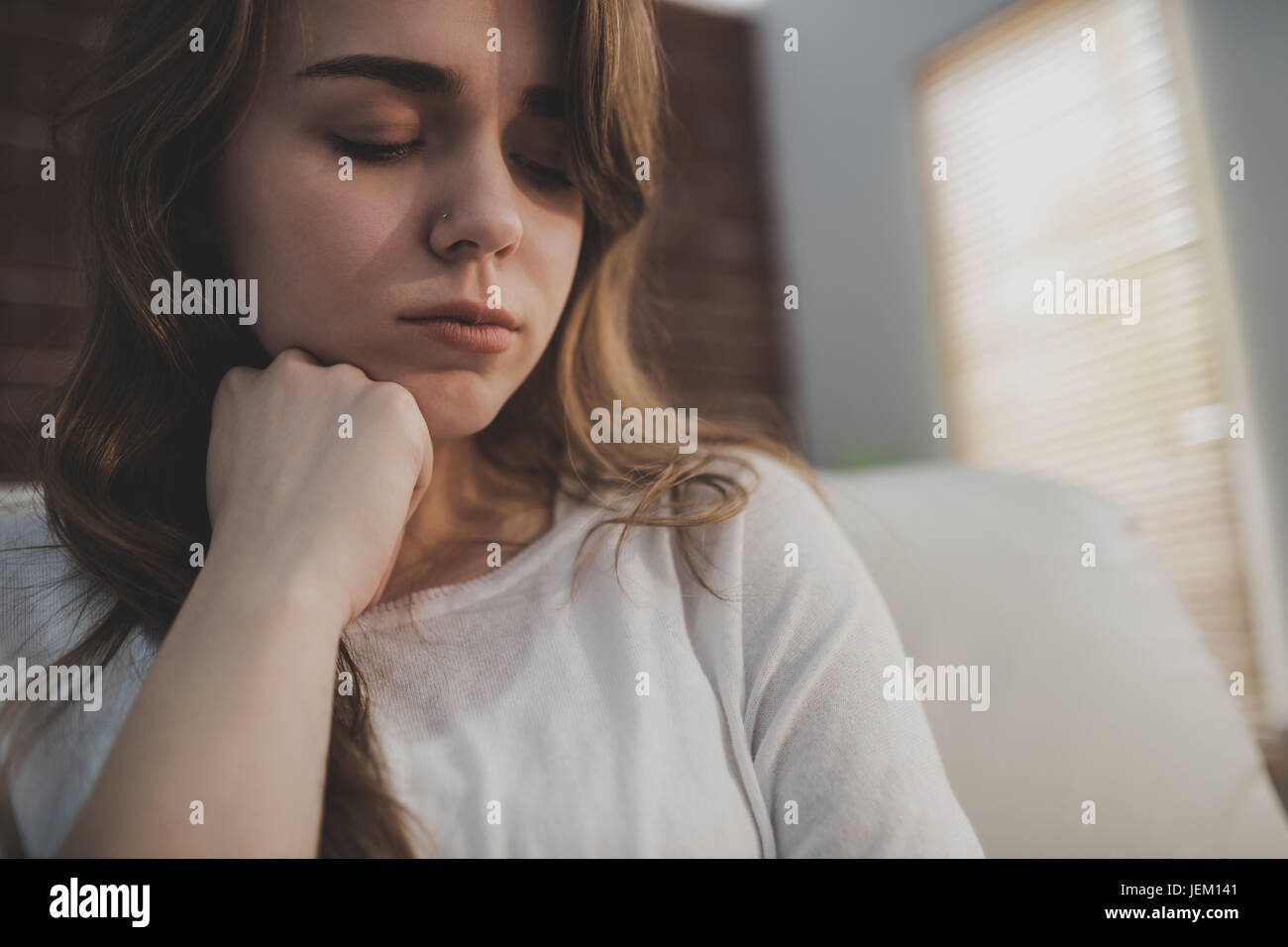 Woman sitting on couch upset hi-res stock photography and images - Alamy