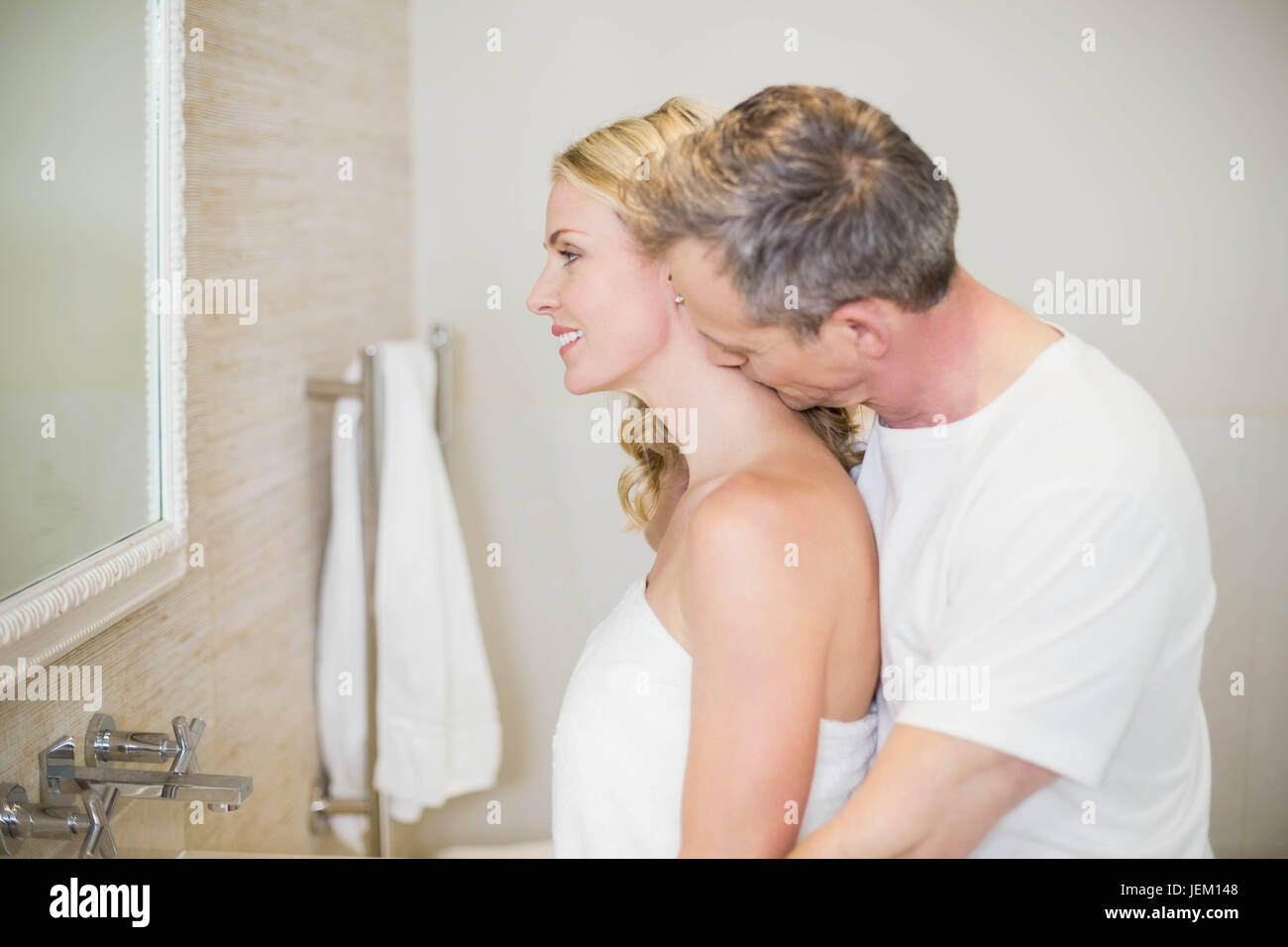 Husband kissing wife on the neck Stock Photo - Alamy