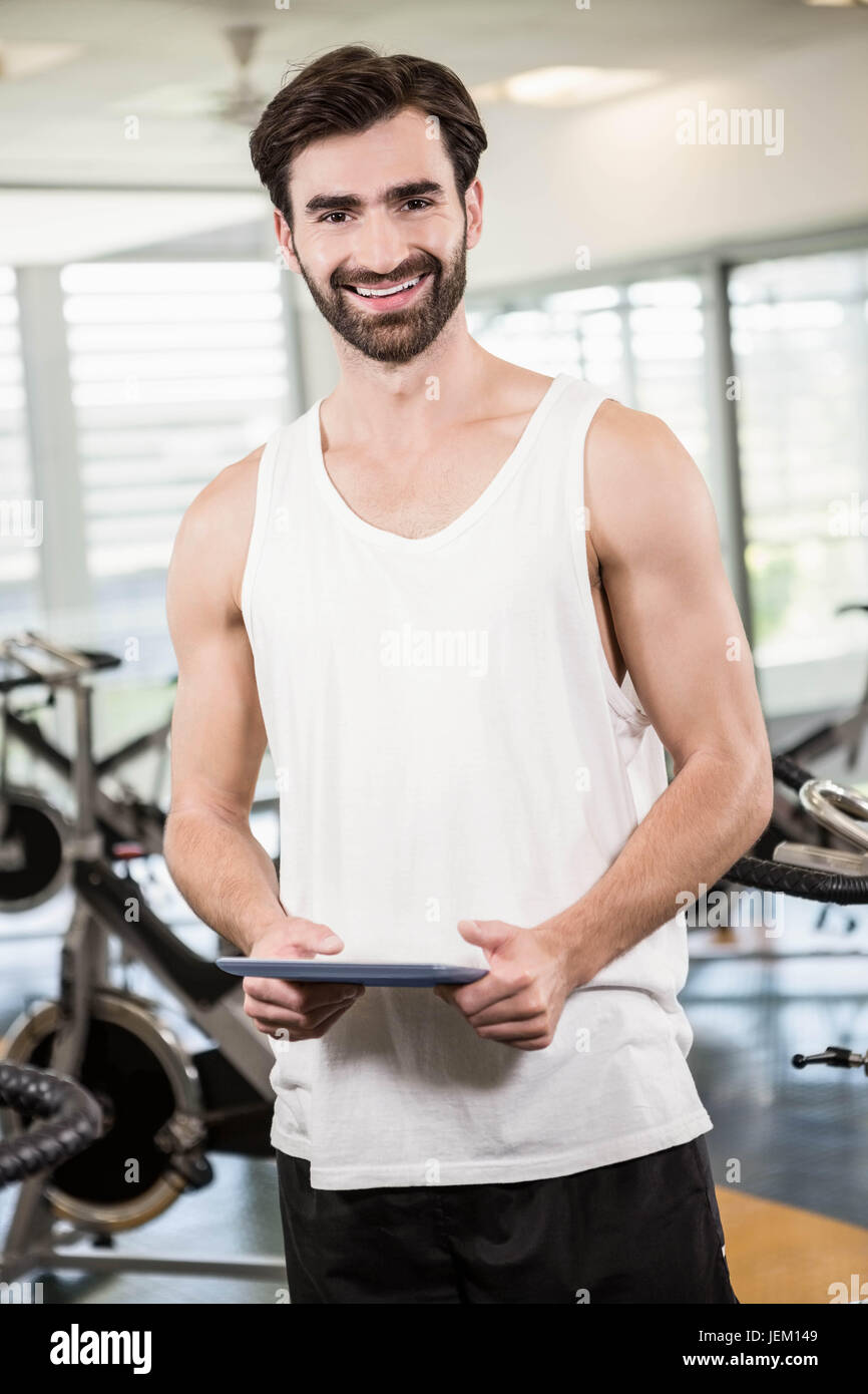 Smiling man holding tablet Stock Photo - Alamy