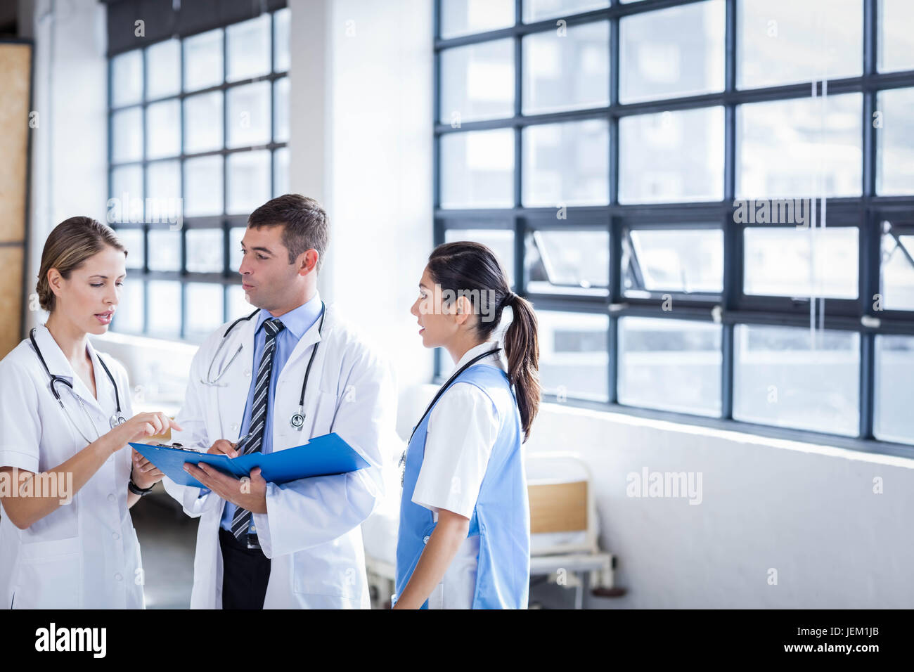 Medical team standing and talking Stock Photo - Alamy