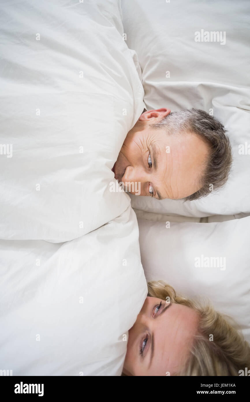 Cute couple cuddling in bed Stock Photo - Alamy