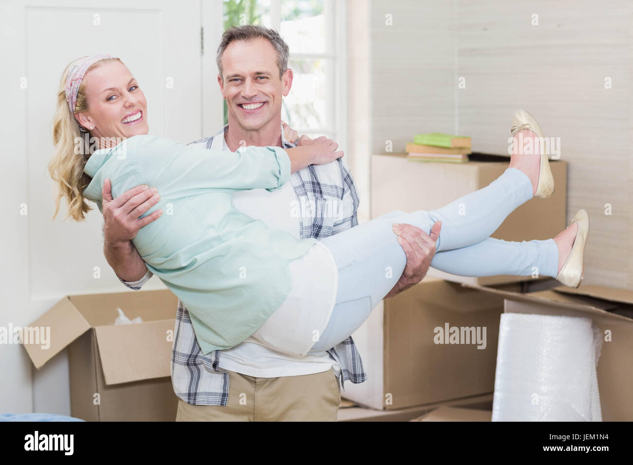 Happy husband carrying his wife Stock Photo - Alamy
